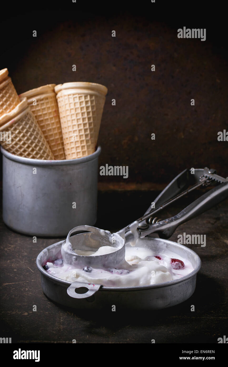 Aluminium plate with vanilla ice cream, mix of frozen berries and ...