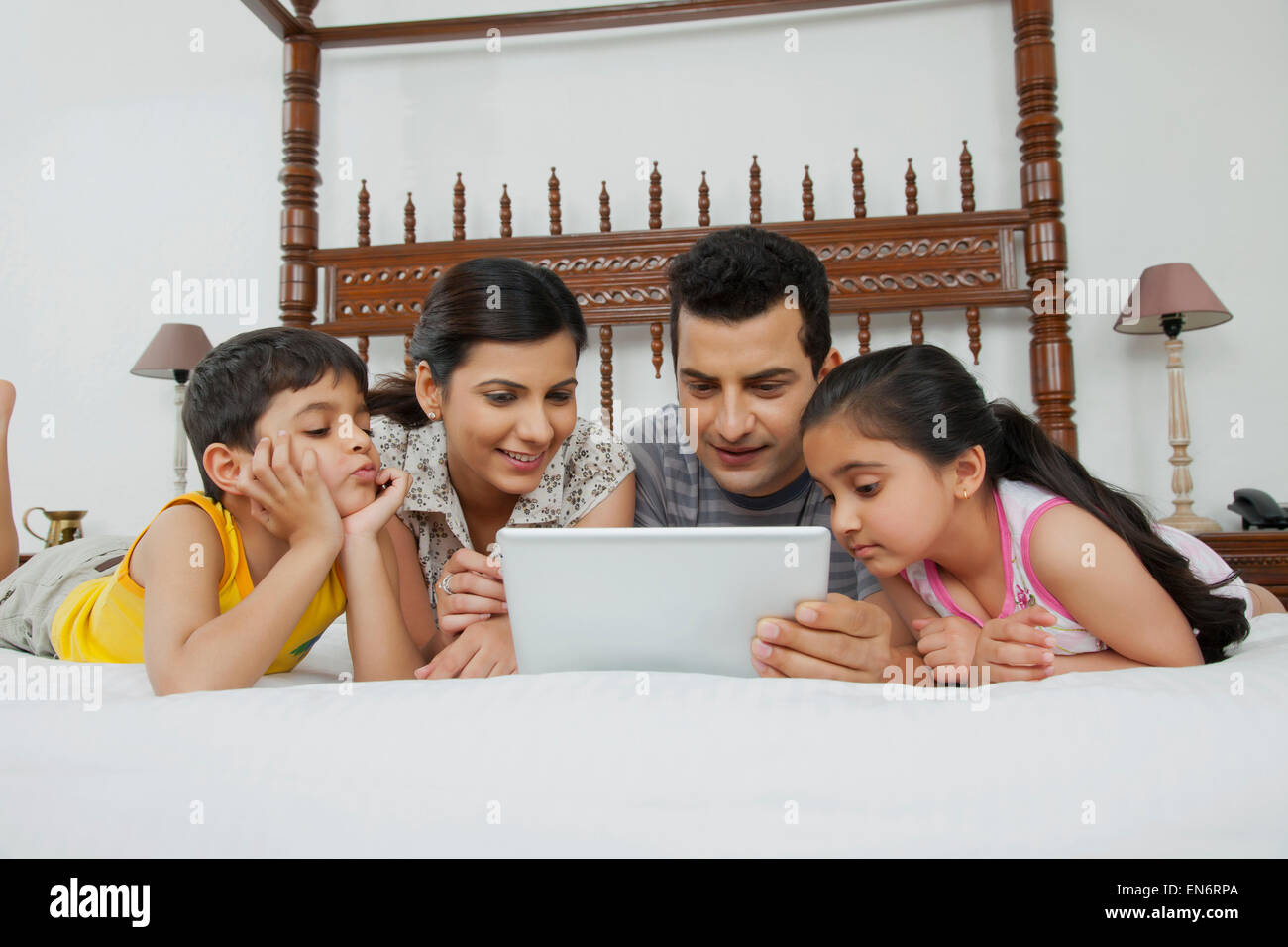 Family looking at a digital tablet Stock Photo - Alamy