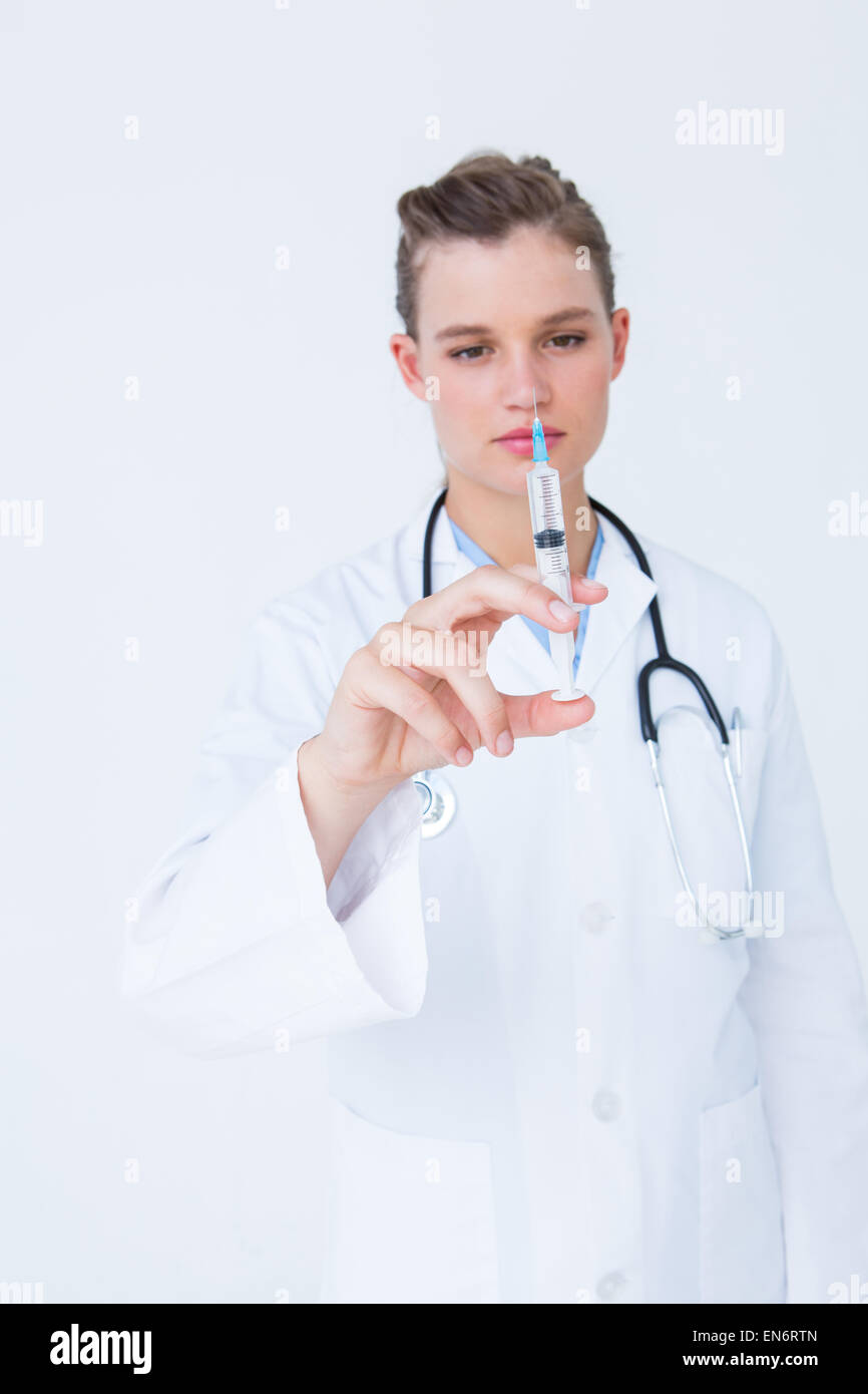 Doctor showing syringe to camera Stock Photo - Alamy