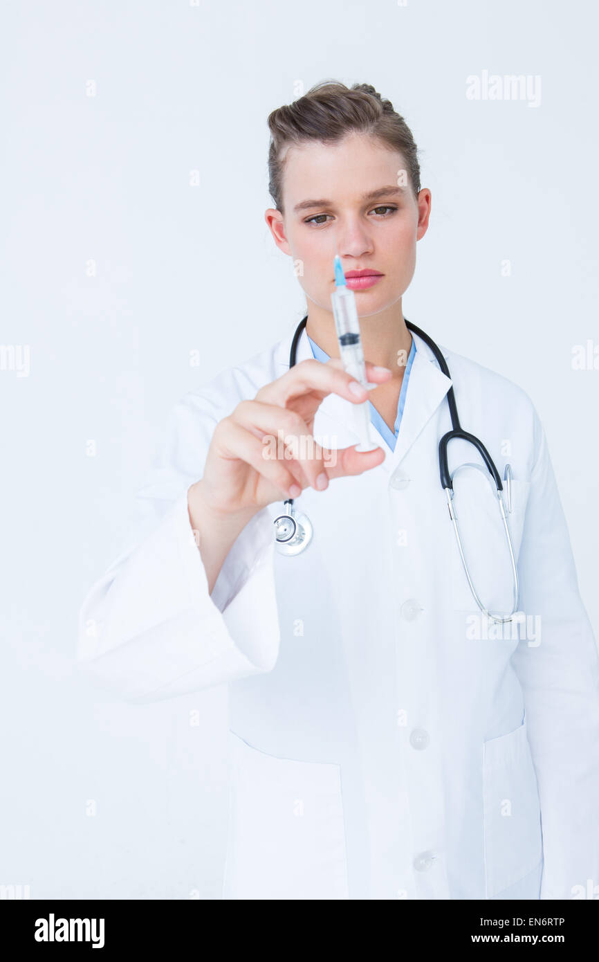Doctor showing syringe to camera Stock Photo - Alamy