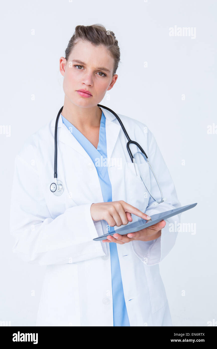 Unsure doctor pointing tablet pc Stock Photo - Alamy