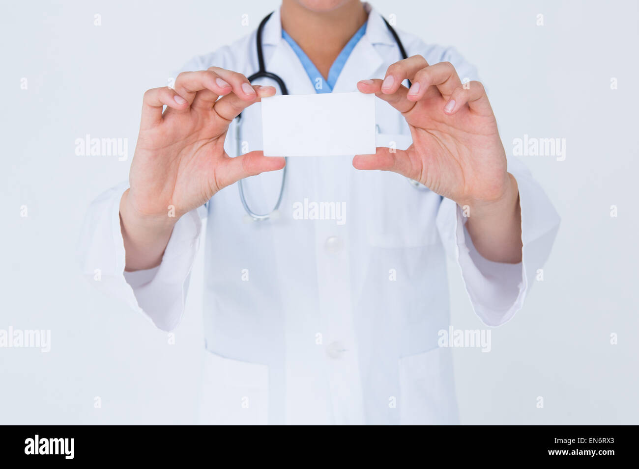 Doctor holding card Stock Photo - Alamy