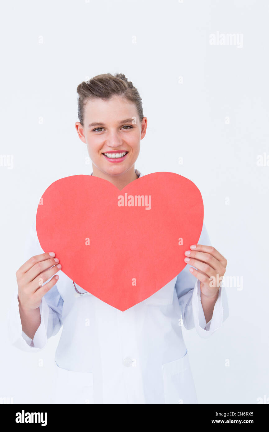 Smiling doctor holding heart card Stock Photo - Alamy Smiling doctor holding heart card Stock Photo - Alamy