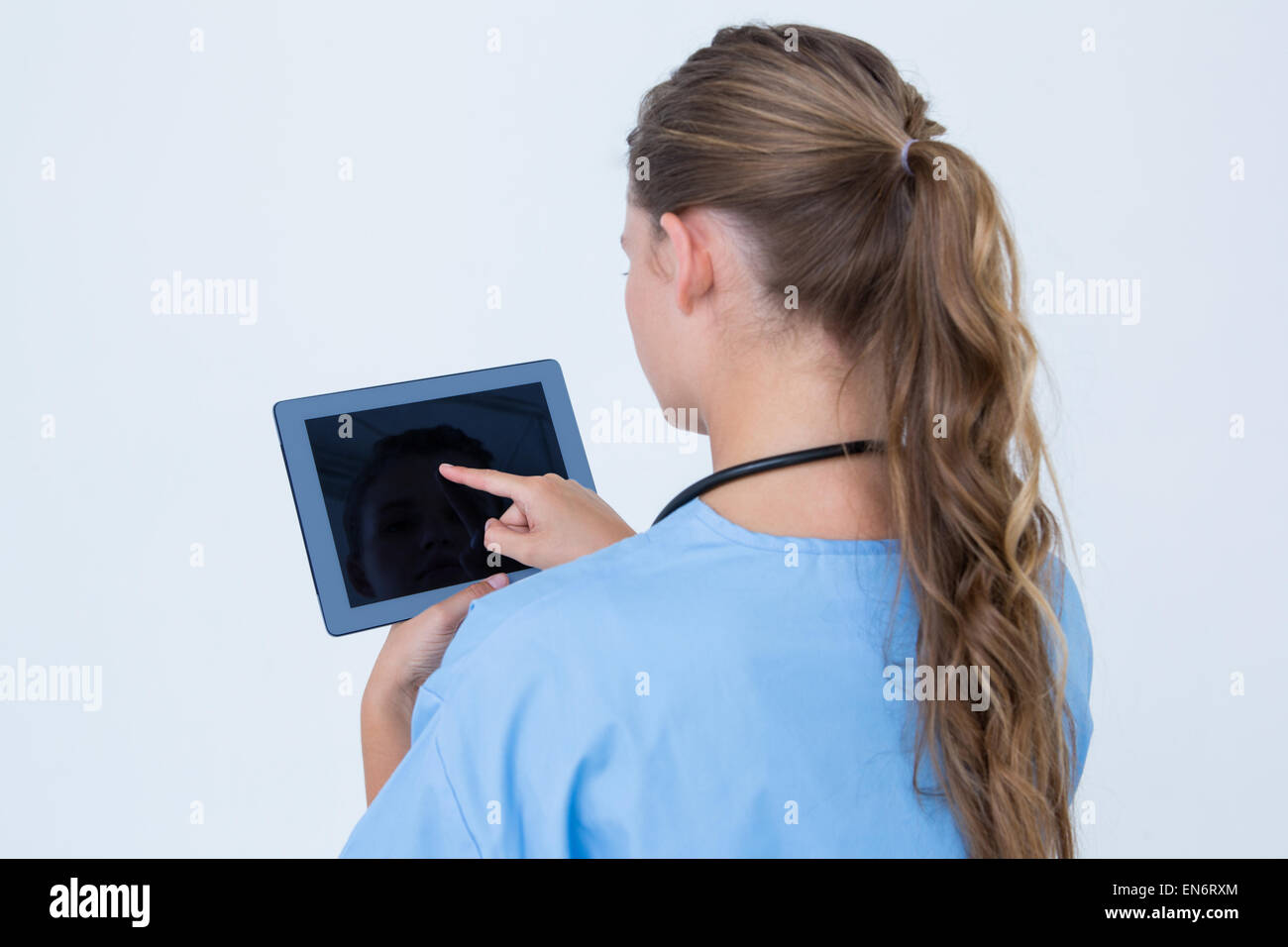 Serious nurse using tablet pc Stock Photo - Alamy