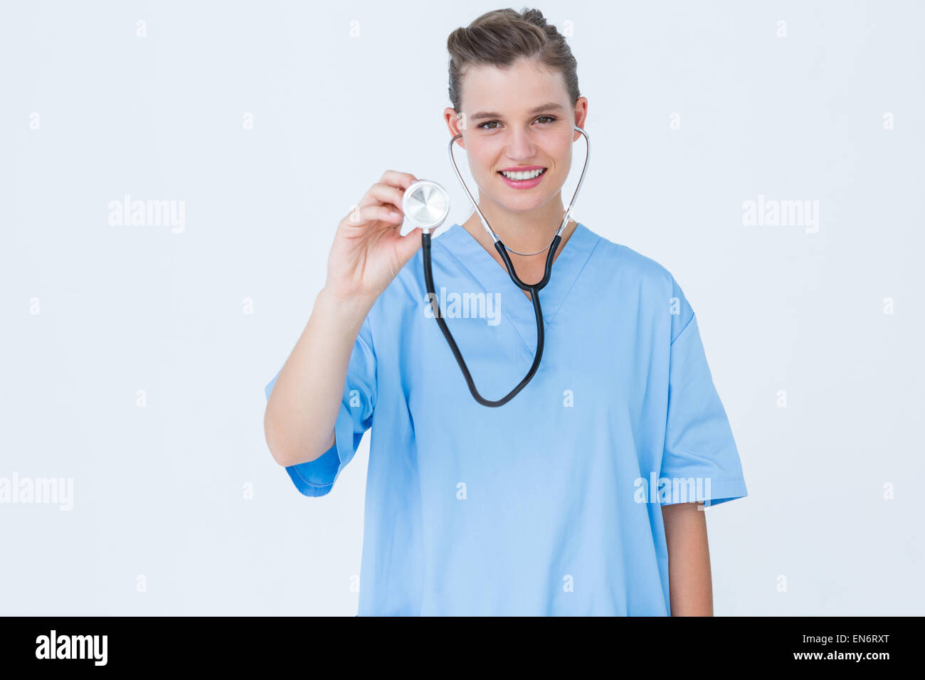 Smiling nurse using stethoscope Stock Photo - Alamy