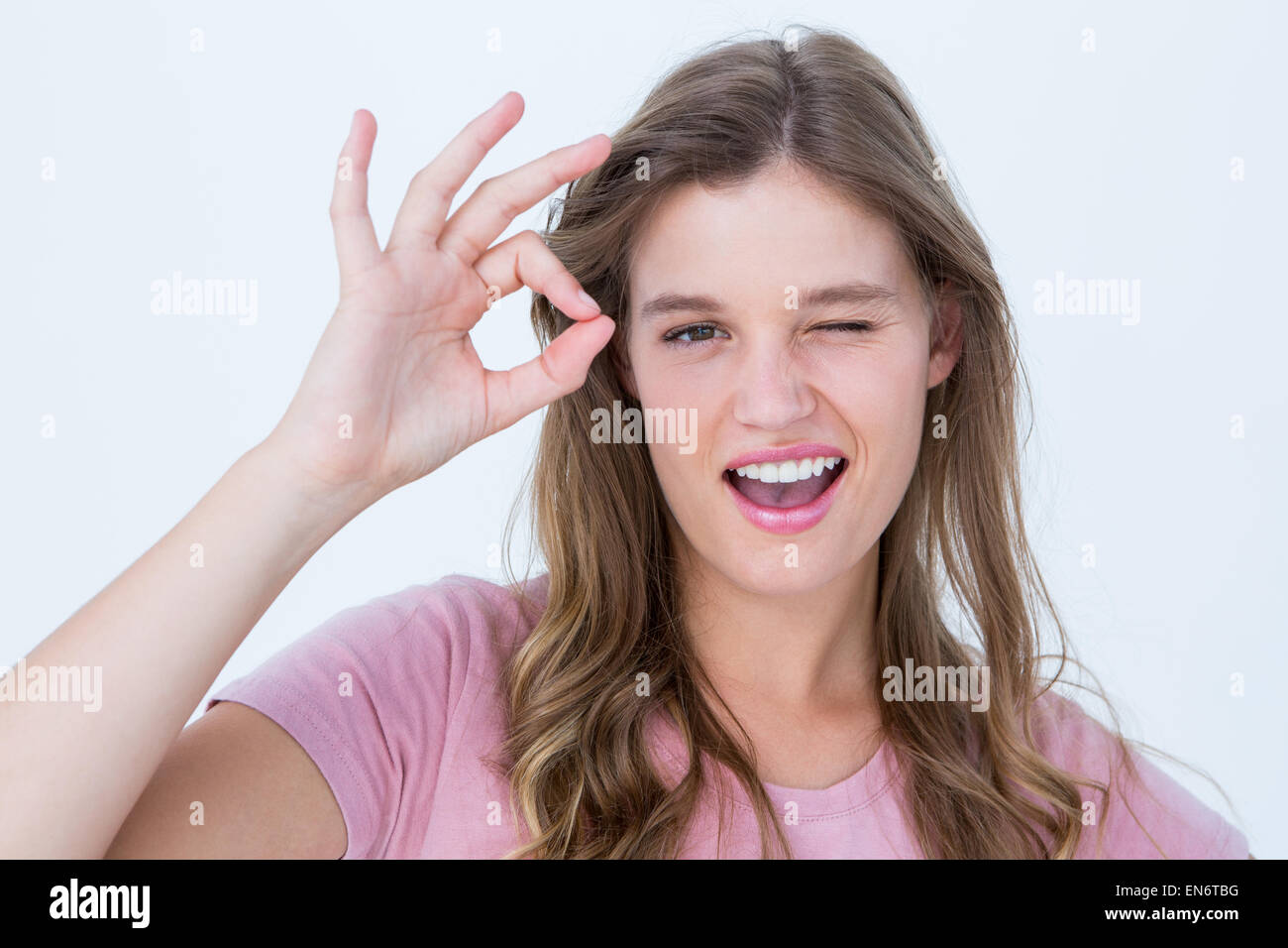 Pretty woman gesturing ok sign Stock Photo - Alamy