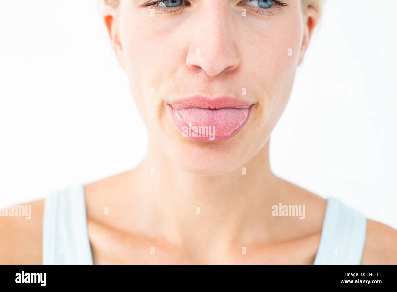 Pretty blonde showing her tongue Stock Photo - Alamy