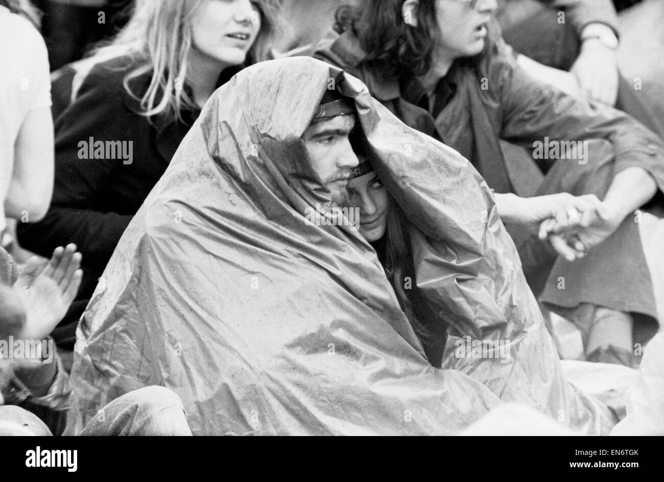 Reading Pop Festival. Young festival goers take cover from the rain ...