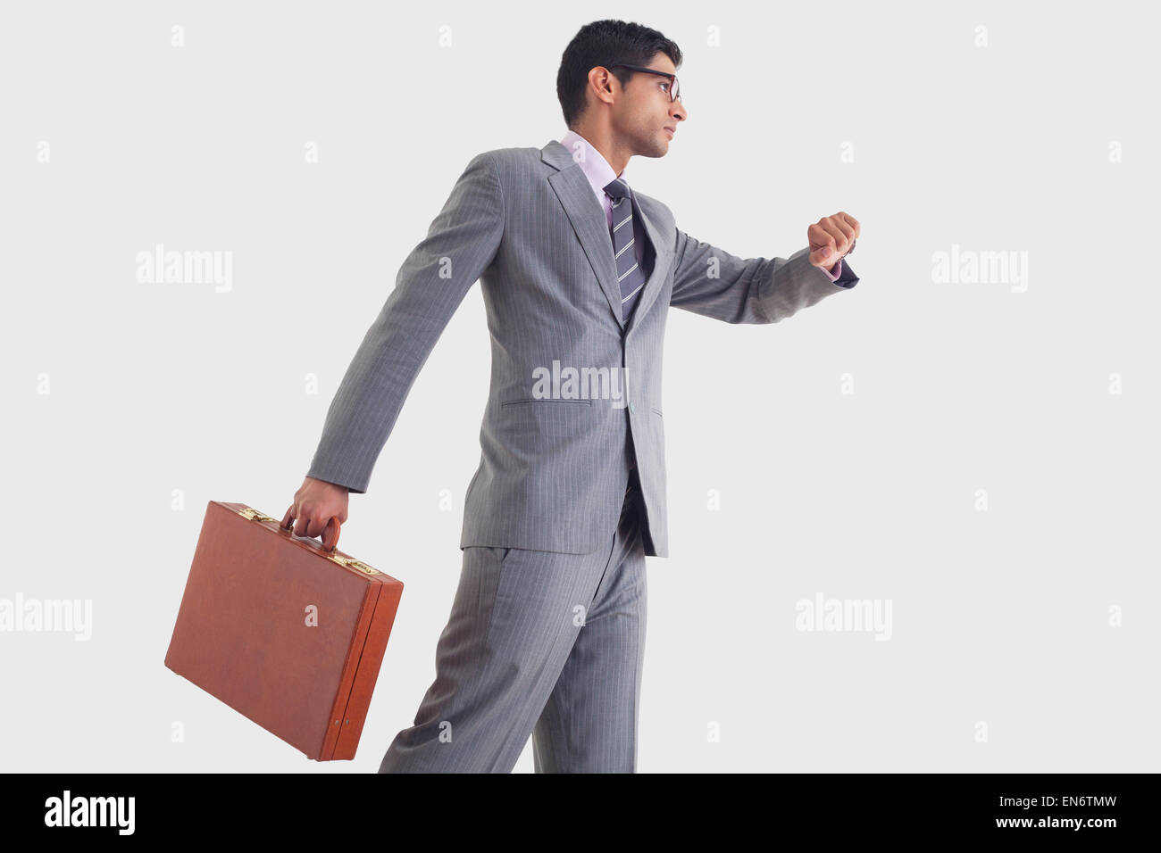 Businessman getting late for work Stock Photo - Alamy