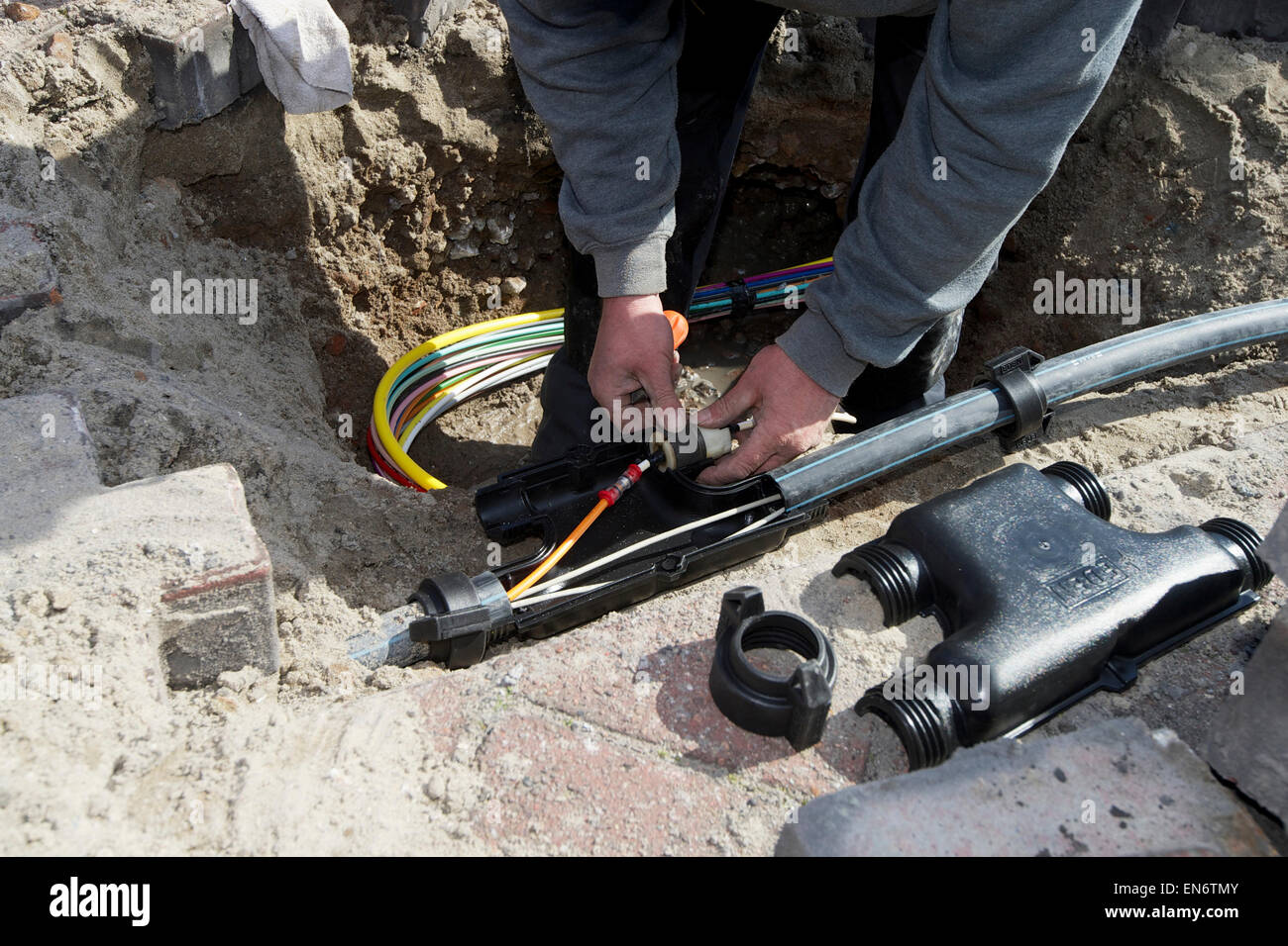 Men laying optical fiber cables Stock Photo - Alamy
