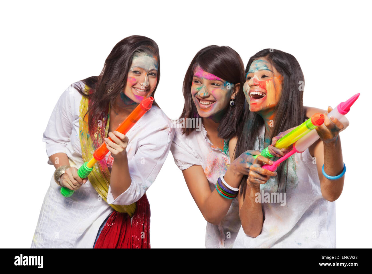 Three women playing holi Stock Photo - Alamy