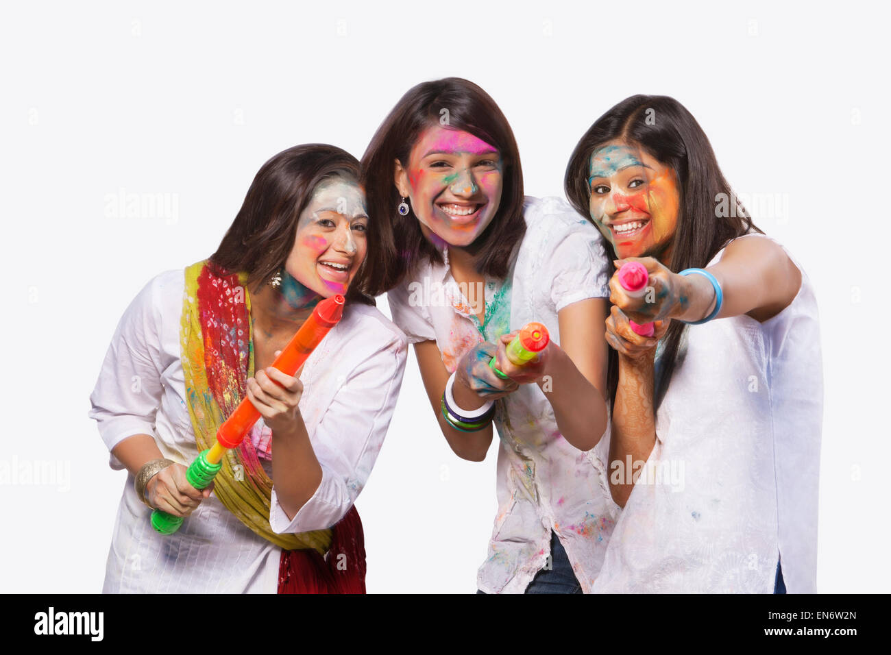 Portrait of three women playing holi Stock Photo - Alamy