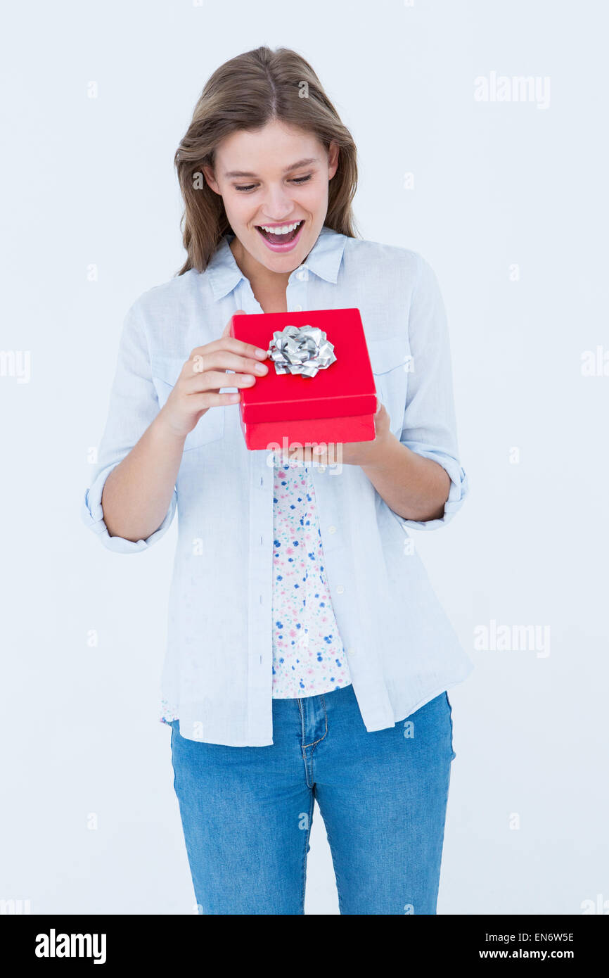 Happy woman opening a present Stock Photo - Alamy