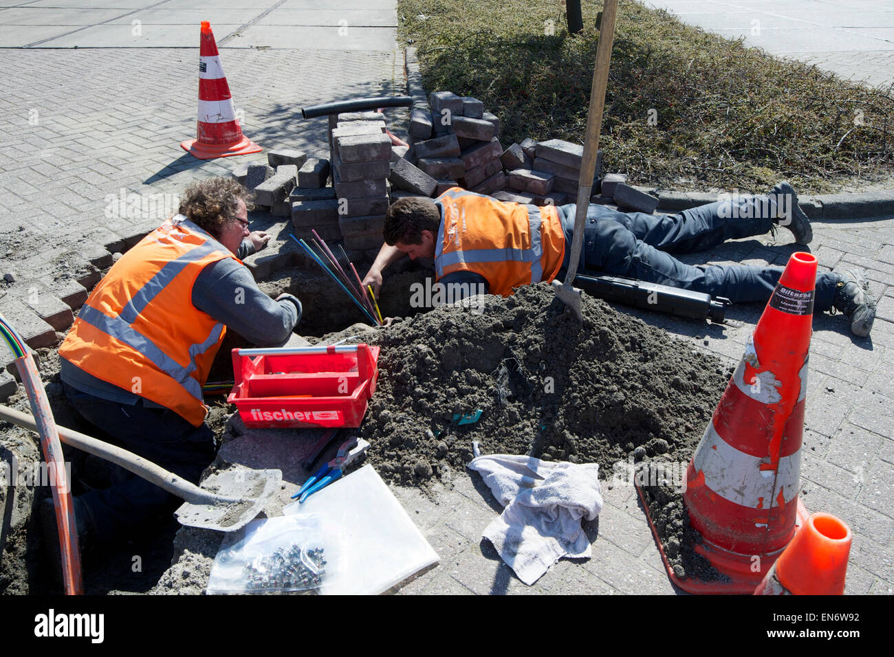 Men laying optical fiber cables Stock Photo - Alamy