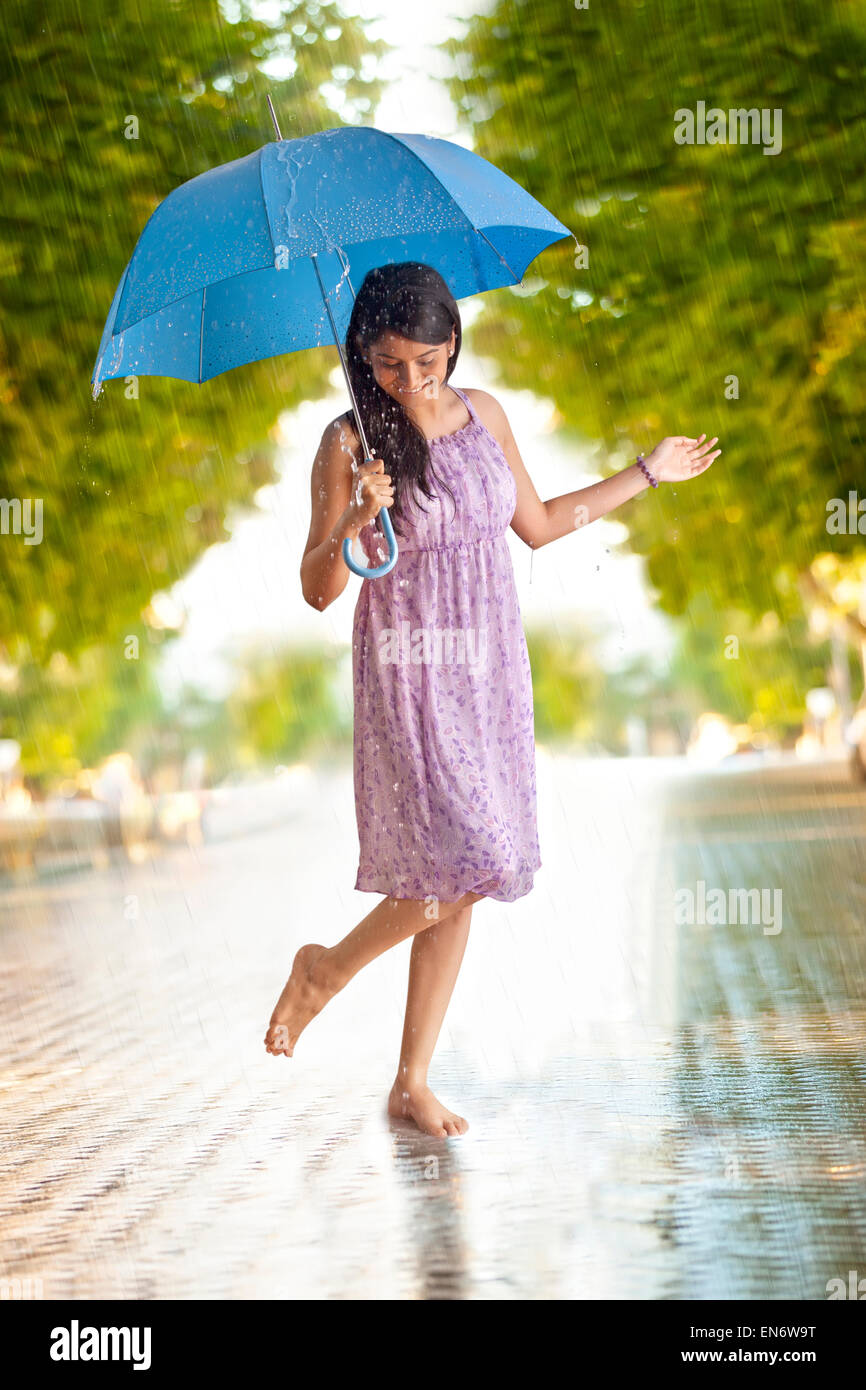 Woman having fun in the rain Stock Photo - Alamy