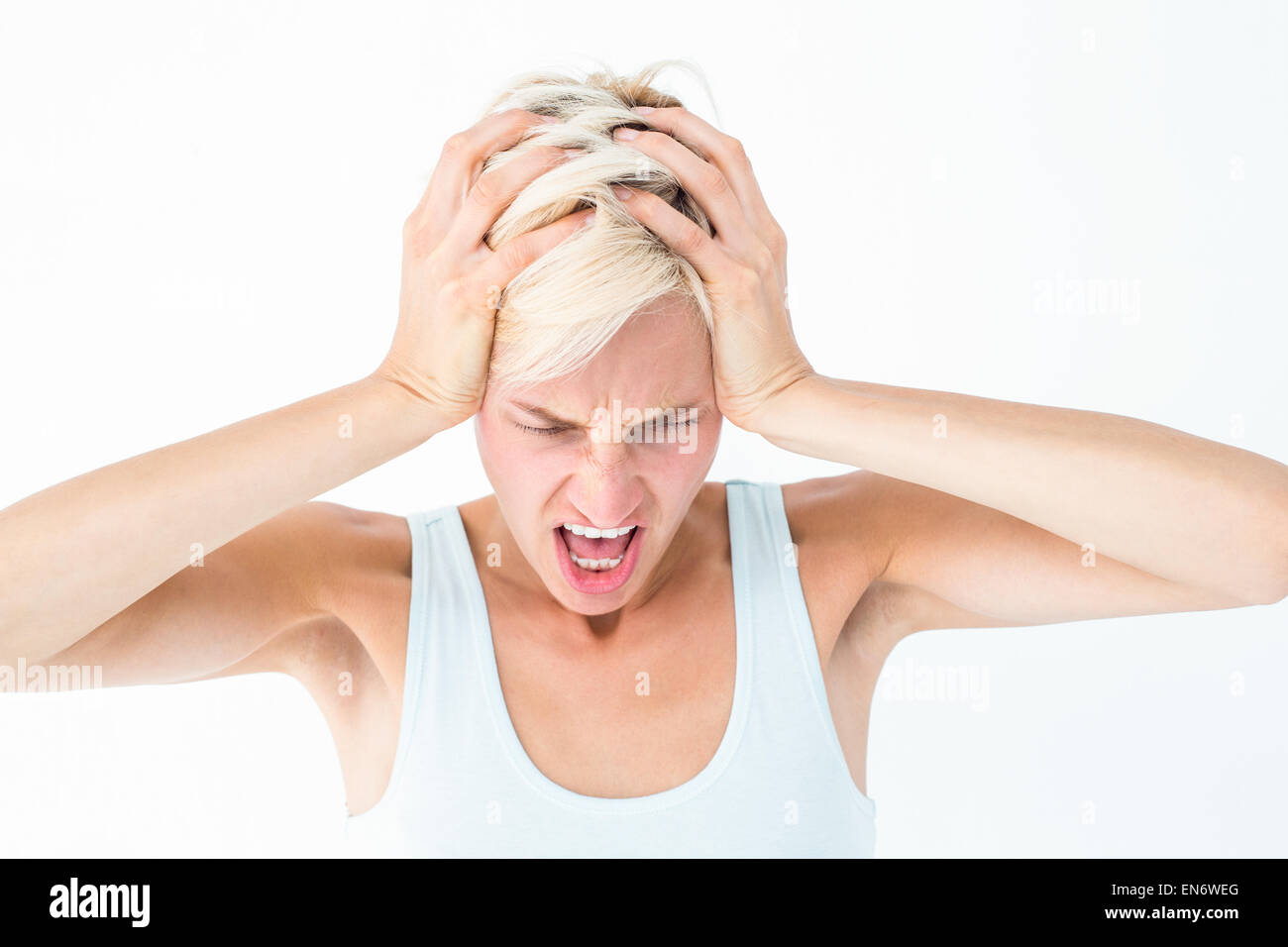 Angry blonde woman screaming and holding her head Stock Photo - Alamy