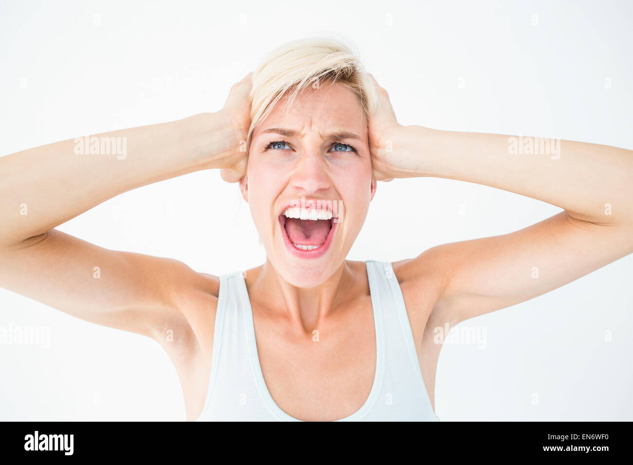 Angry blonde screaming and holding her head Stock Photo - Alamy