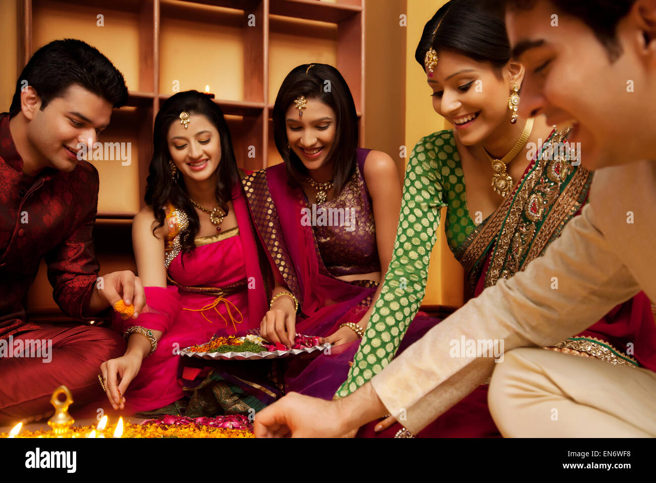 Friends making a rangoli Stock Photo - Alamy