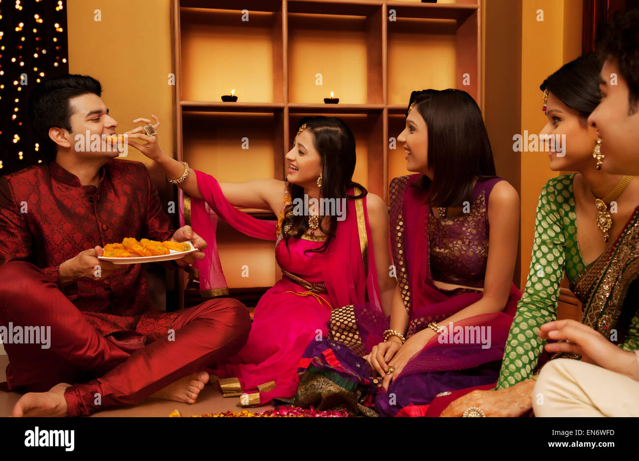 Woman feeding her friend sweets Stock Photo - Alamy