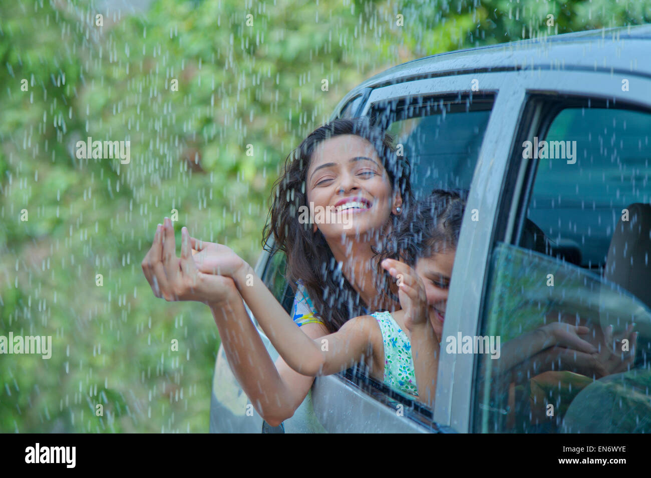 Mother and daughter enjoying the rain Stock Photo - Alamy