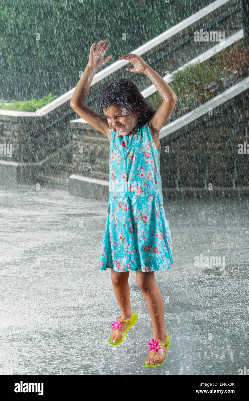 Little girl jumping in the rain Stock Photo - Alamy
