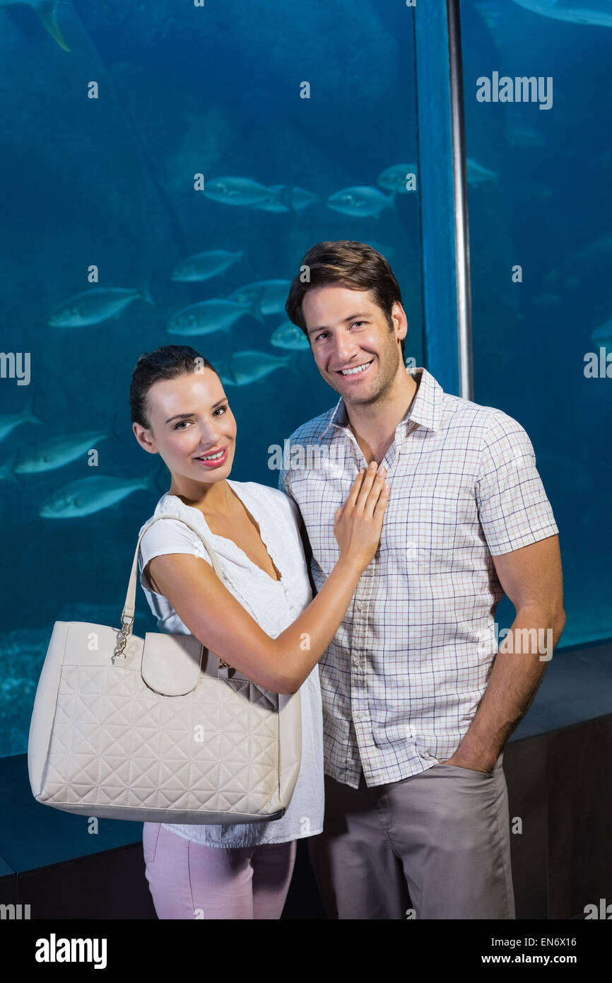 Happy couple beside the fish tank Stock Photo - Alamy