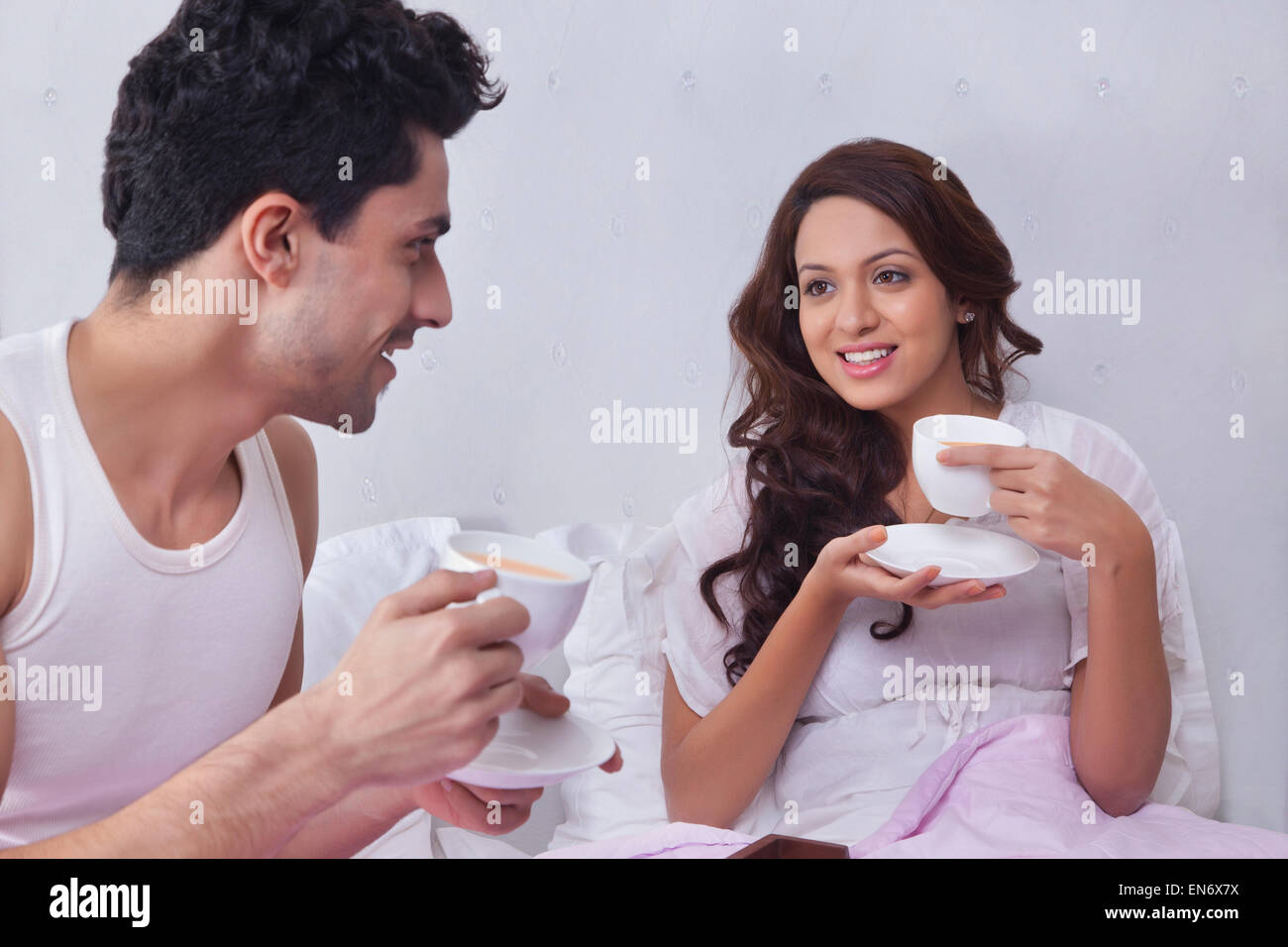 Couple having coffee in bed Stock Photo - Alamy