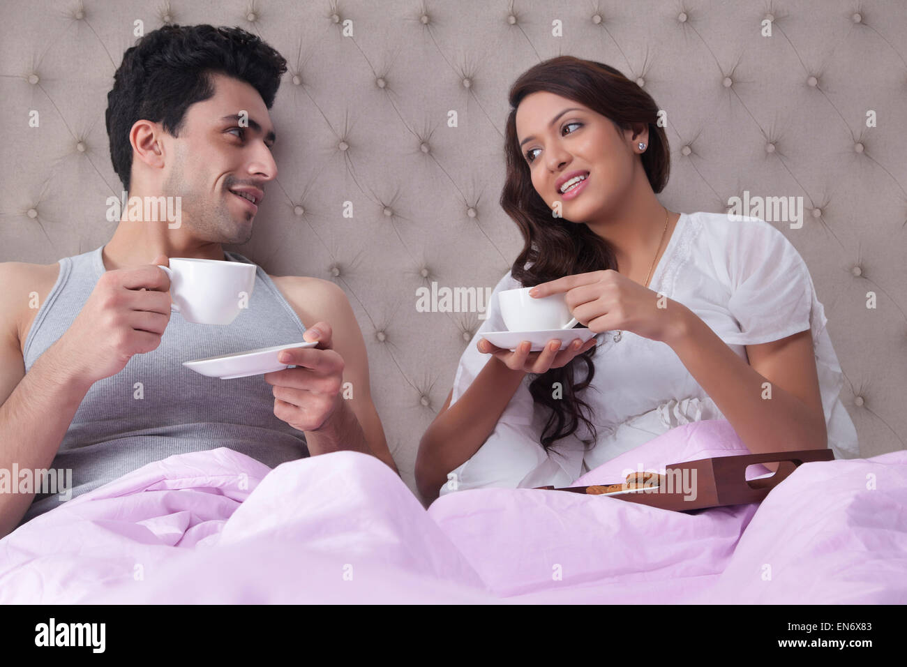 Couple having coffee in bed Stock Photo - Alamy