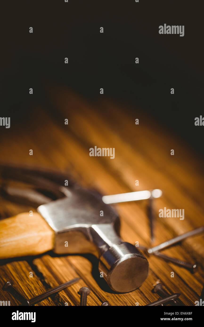 Hammer and nails laid out on table Stock Photo - Alamy