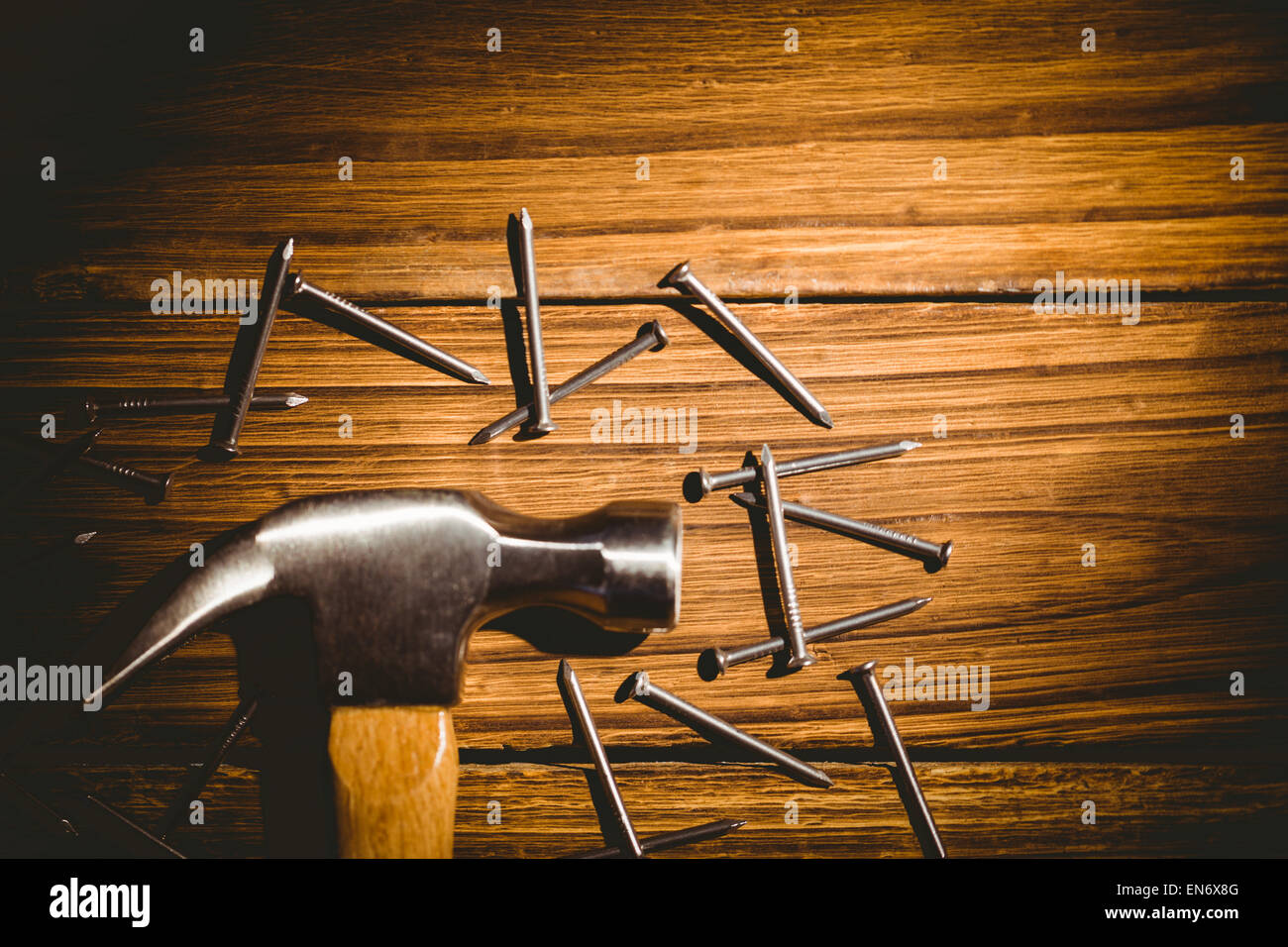 Hammer and nails laid out on table Stock Photo - Alamy