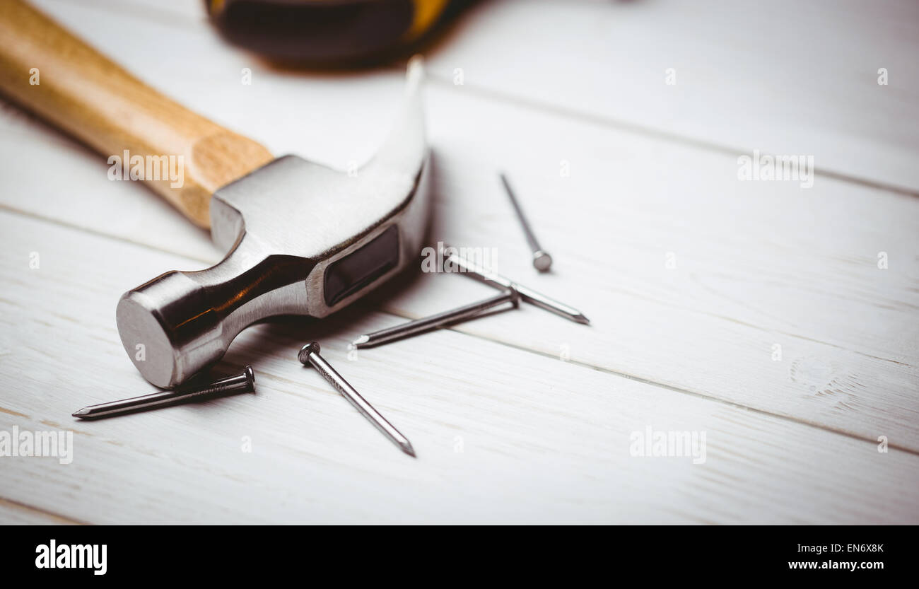 Hammer and nails laid out on table Stock Photo - Alamy