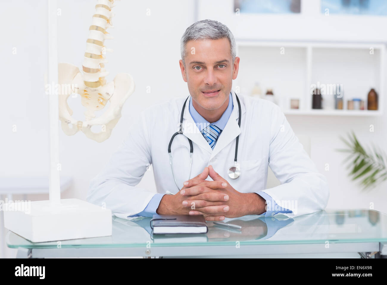 Male doctor smiling camera sitting hi-res stock photography and images ...