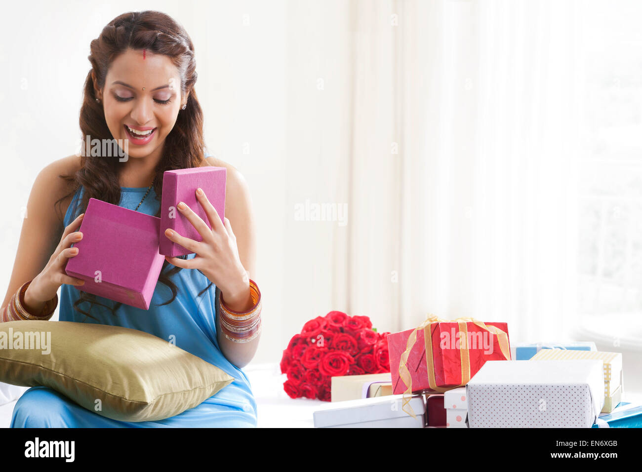 Woman opening a gift box Stock Photo - Alamy