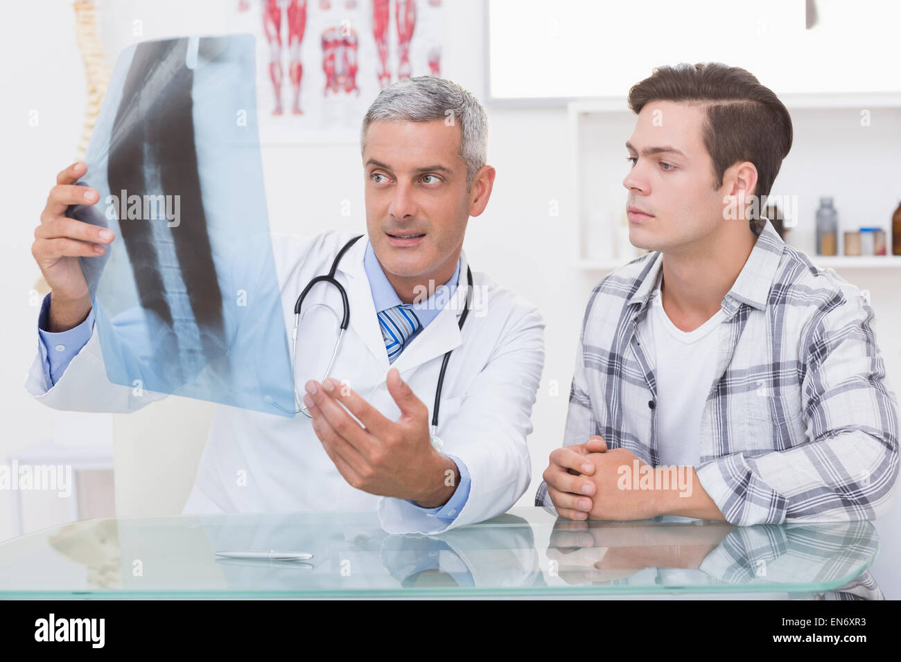 Doctor showing X rays to his patient Stock Photo - Alamy