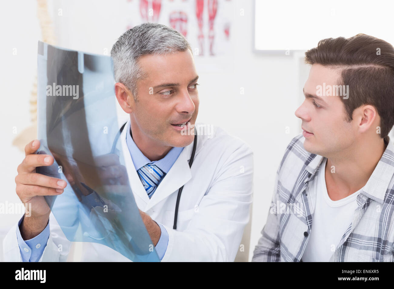 Doctor showing X rays to his patient Stock Photo - Alamy