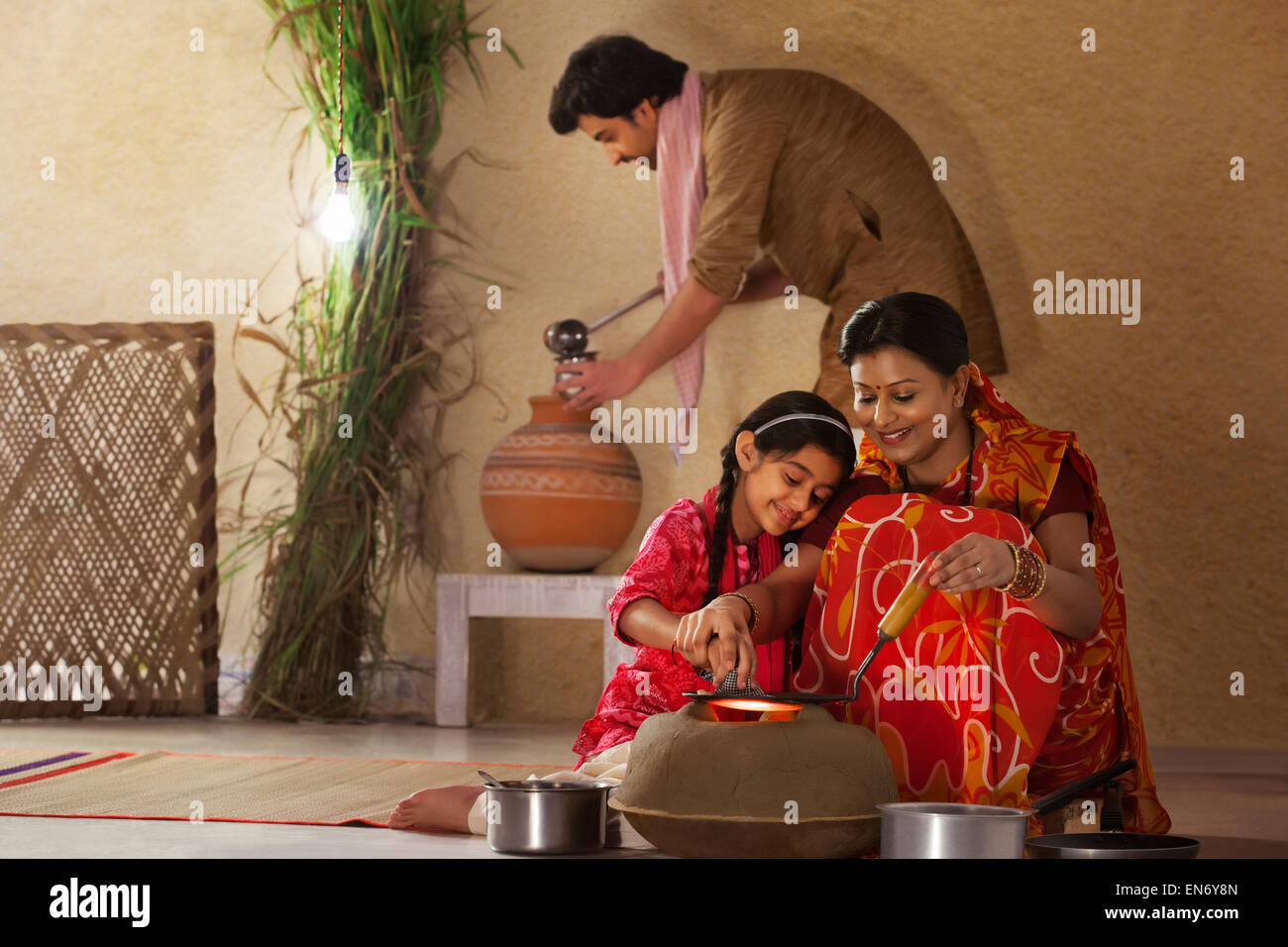 Rural mother teaching daughter to cook Stock Photo - Alamy