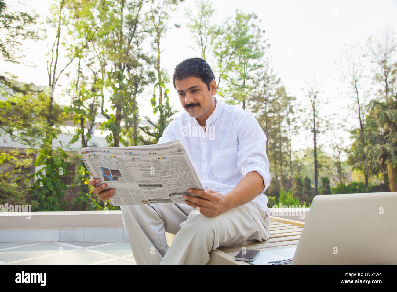 Man reading a newspaper Stock Photo - Alamy