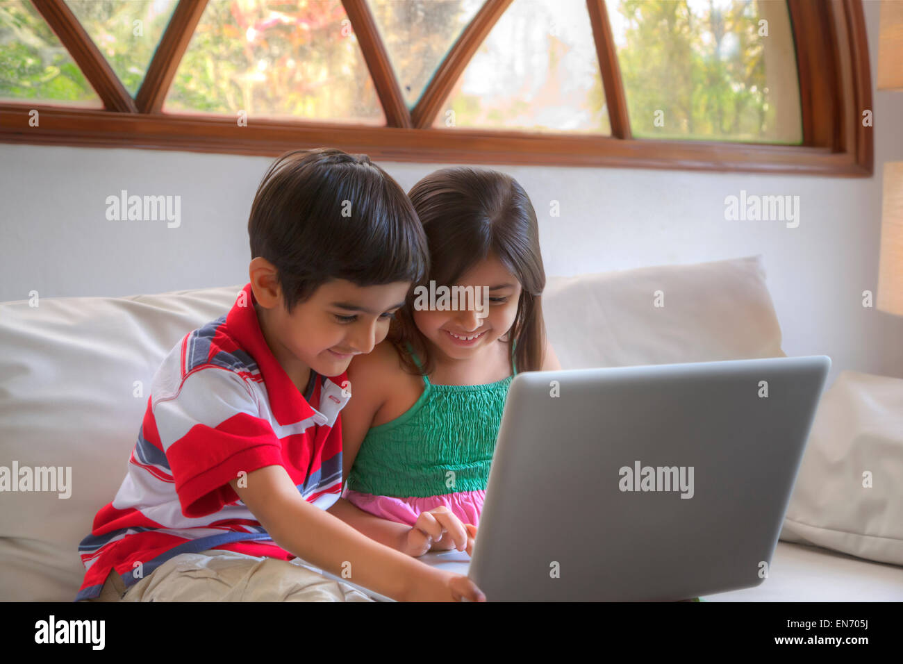 Brother and sister with laptop Stock Photo - Alamy