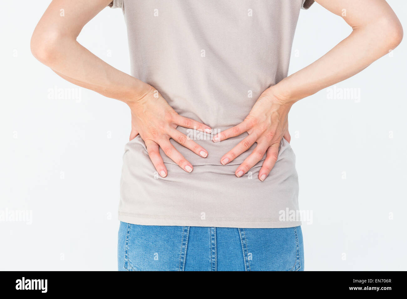 Woman having a back ache and holding her back Stock Photo - Alamy