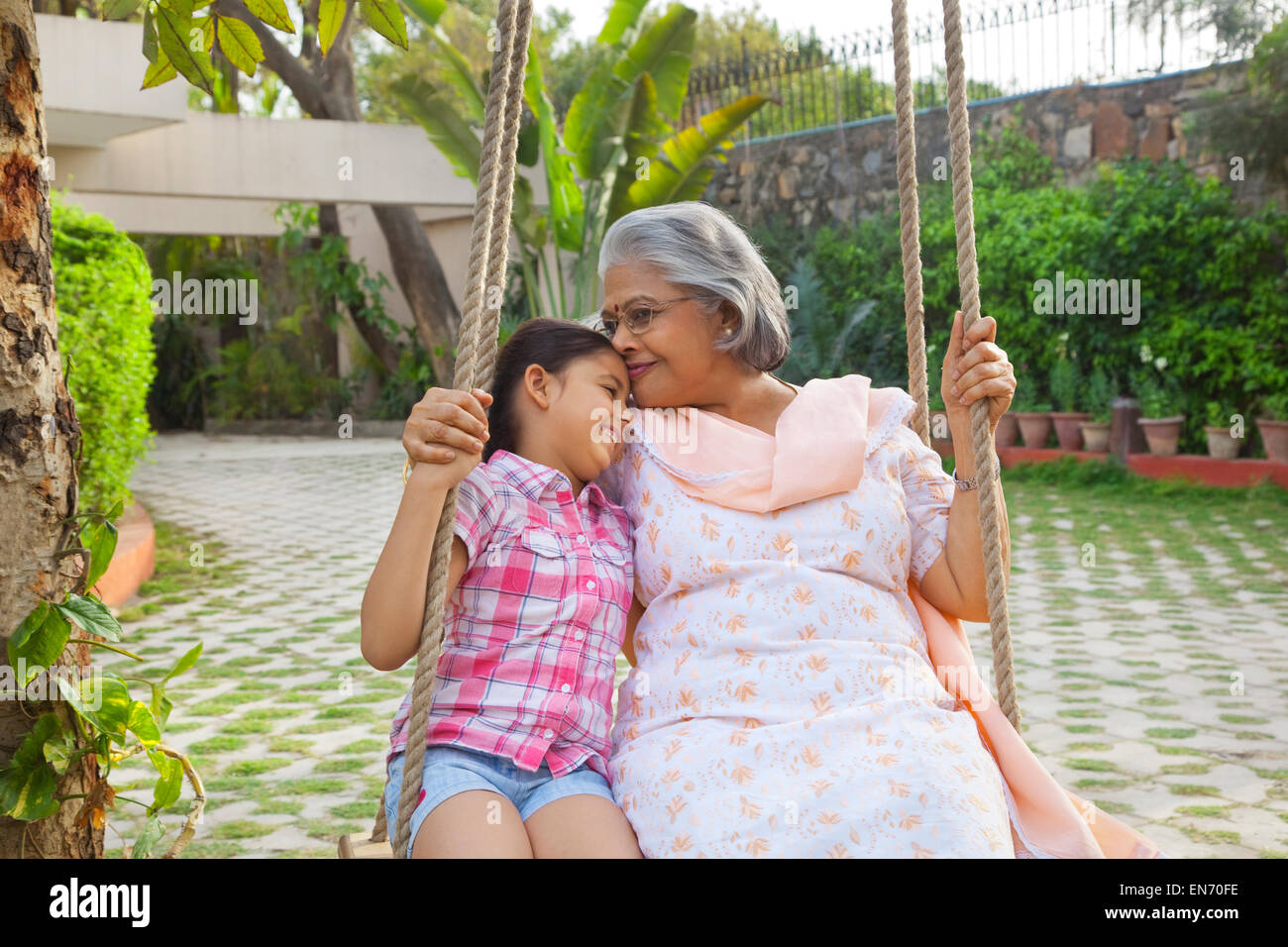Granddaughter kissing grandmother hi-res stock photography and images ...