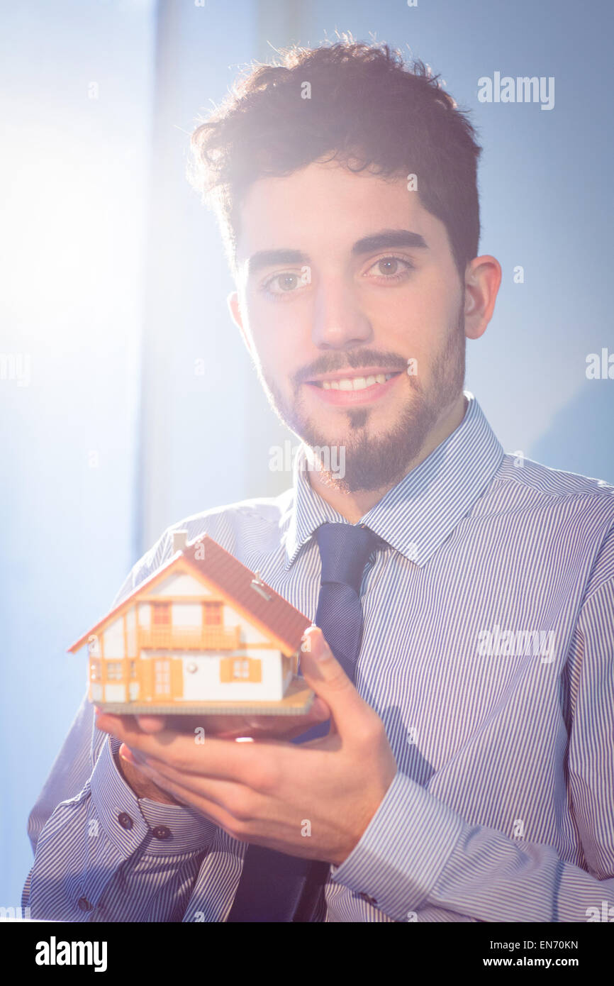 Businessman showing a key Stock Photo - Alamy