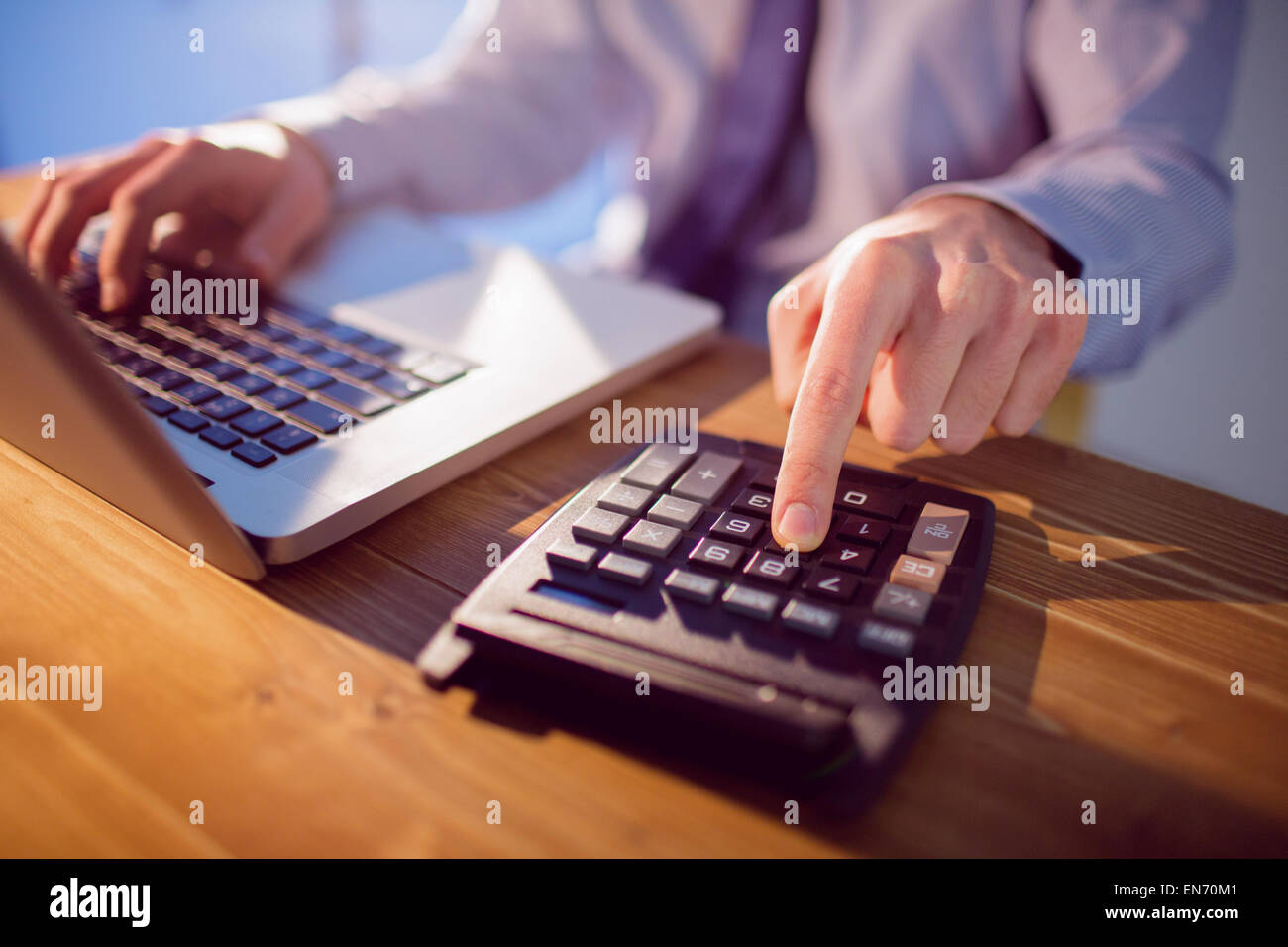 Businessman using calculator laptop computer hi-res stock photography ...