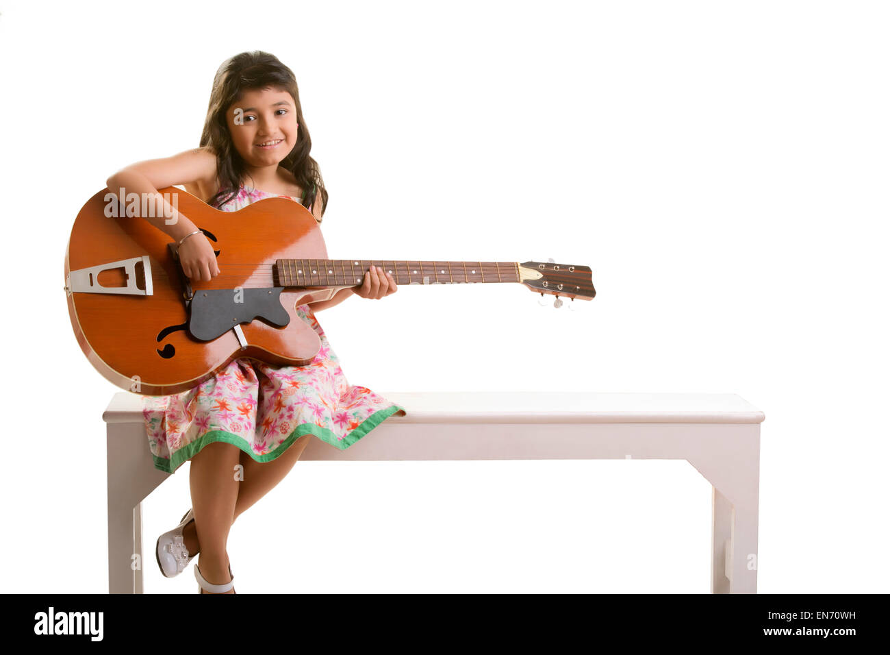 Indian girl enjoying guitar Cut Out Stock Images & Pictures - Alamy