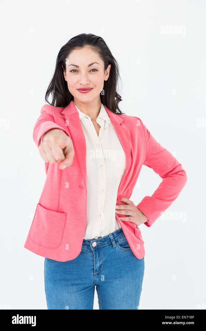 Smiling beautiful woman pointing with her finger Stock Photo - Alamy