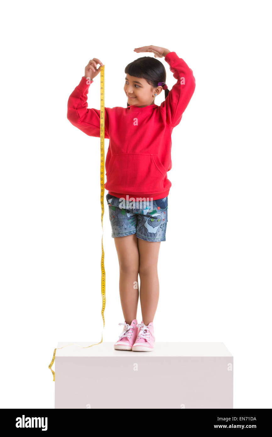 Girl measuring her height Stock Photo - Alamy