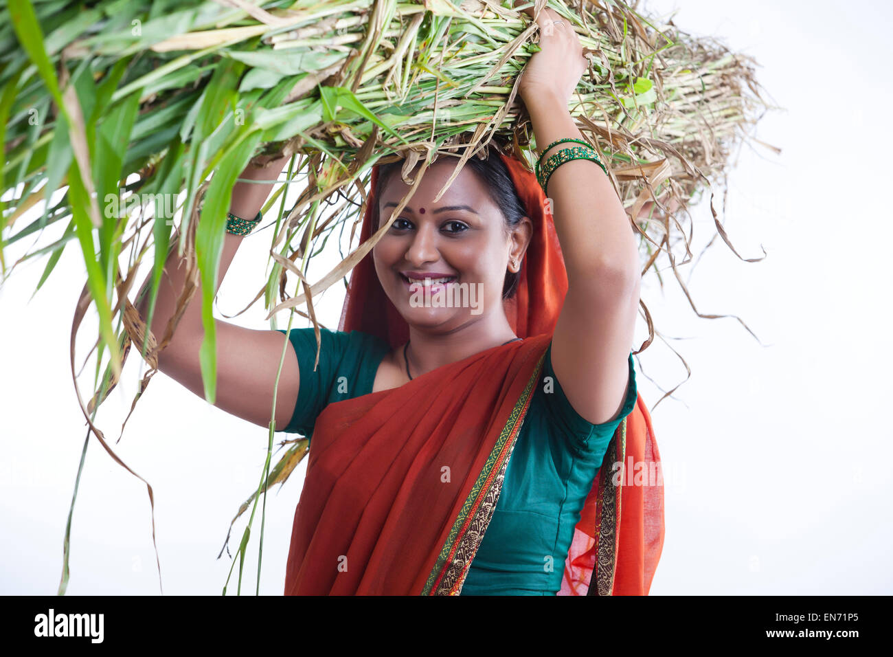 Woman carrying fodder hi-res stock photography and images - Alamy