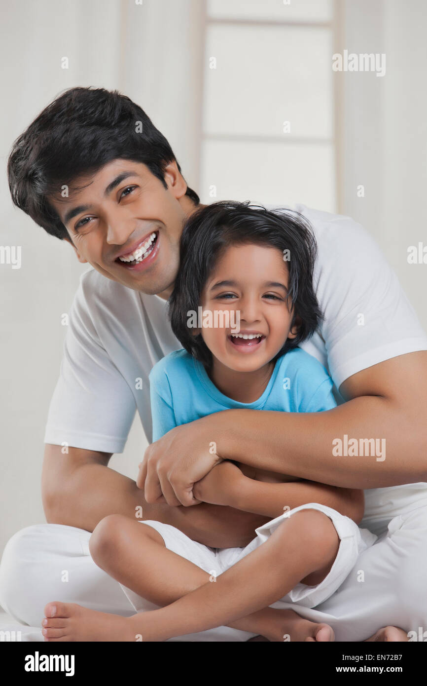 Portrait of father and son smiling Stock Photo - Alamy