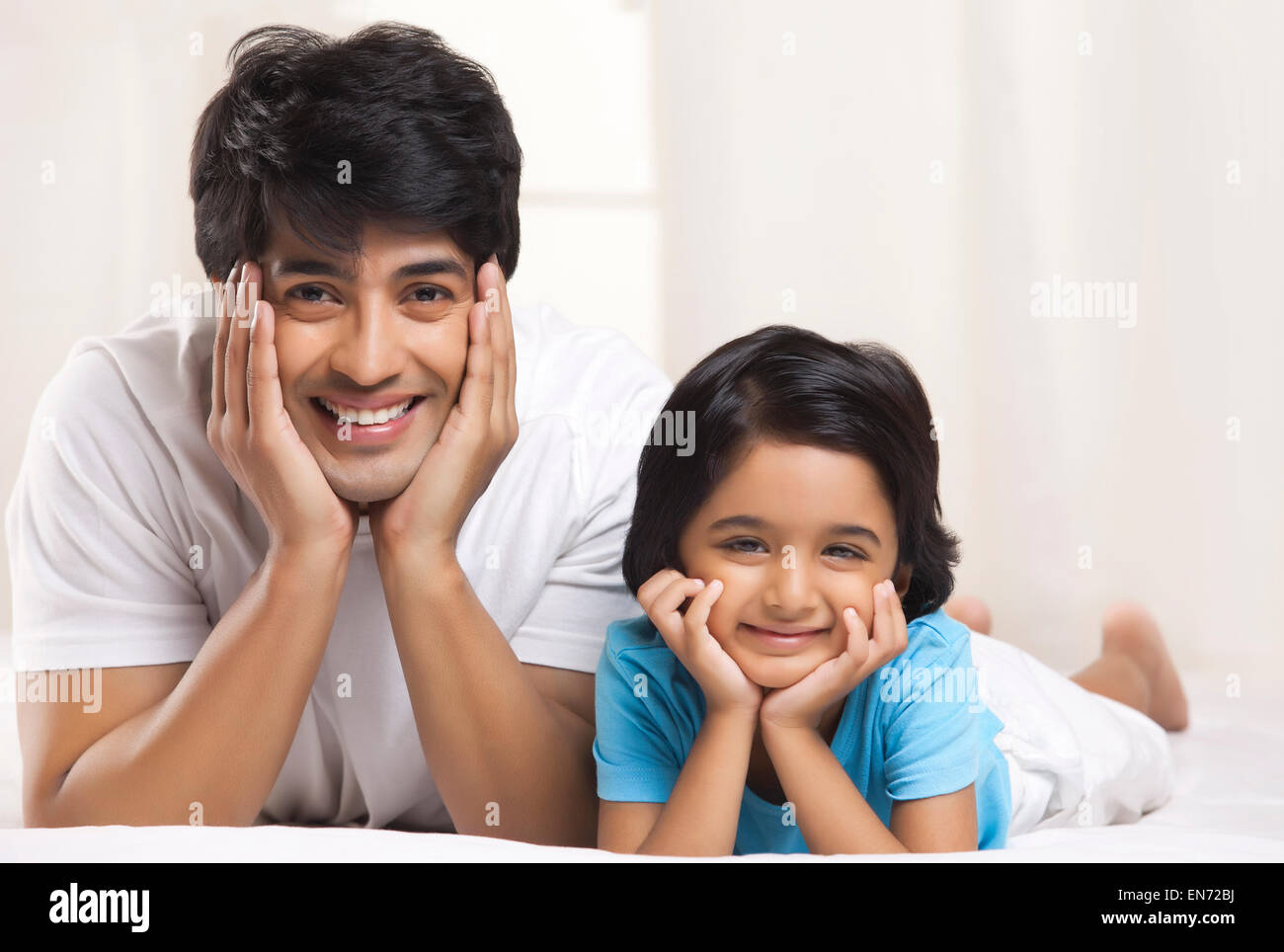 Portrait of father and son smiling Stock Photo - Alamy