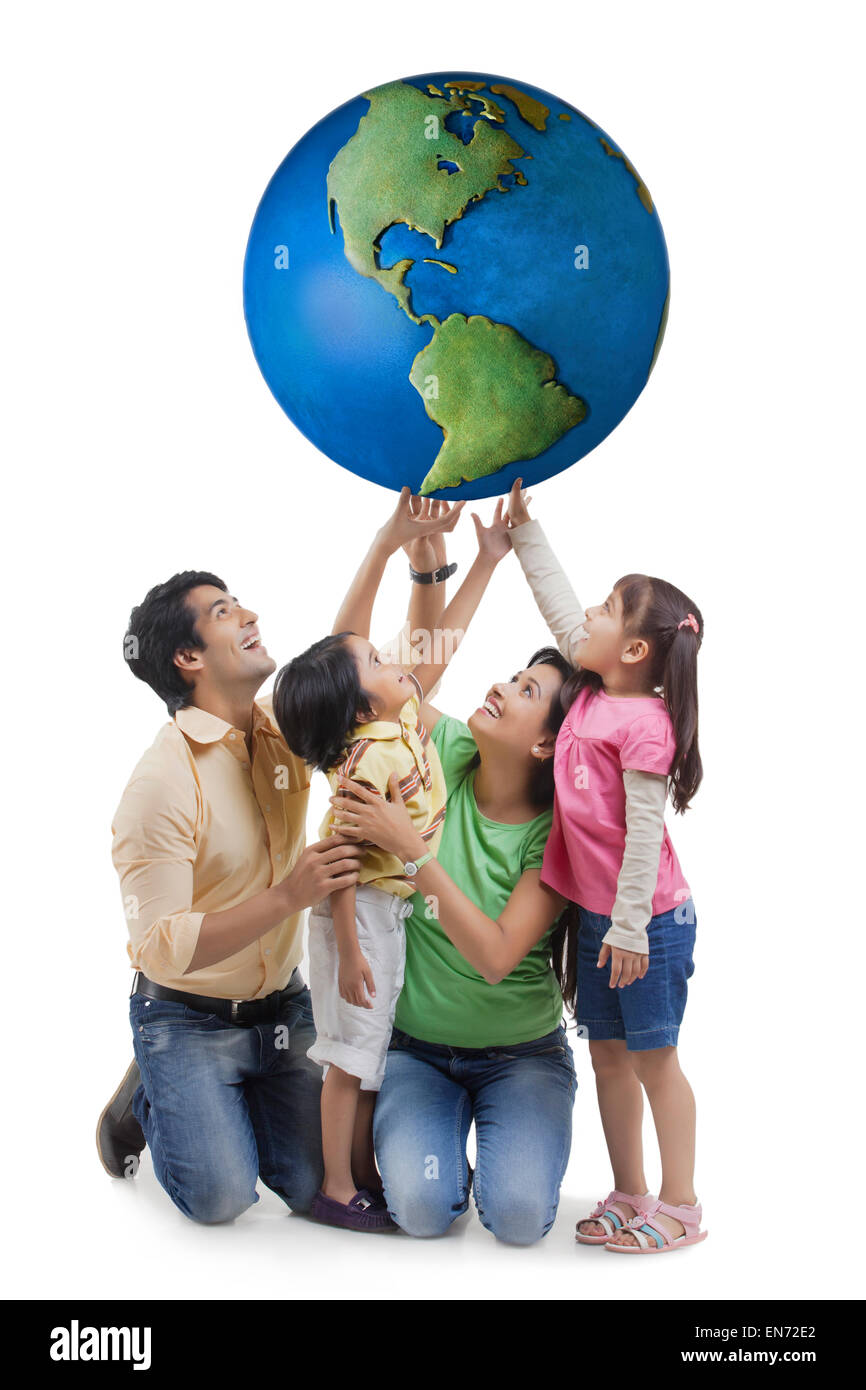 Family touching world globe Stock Photo - Alamy