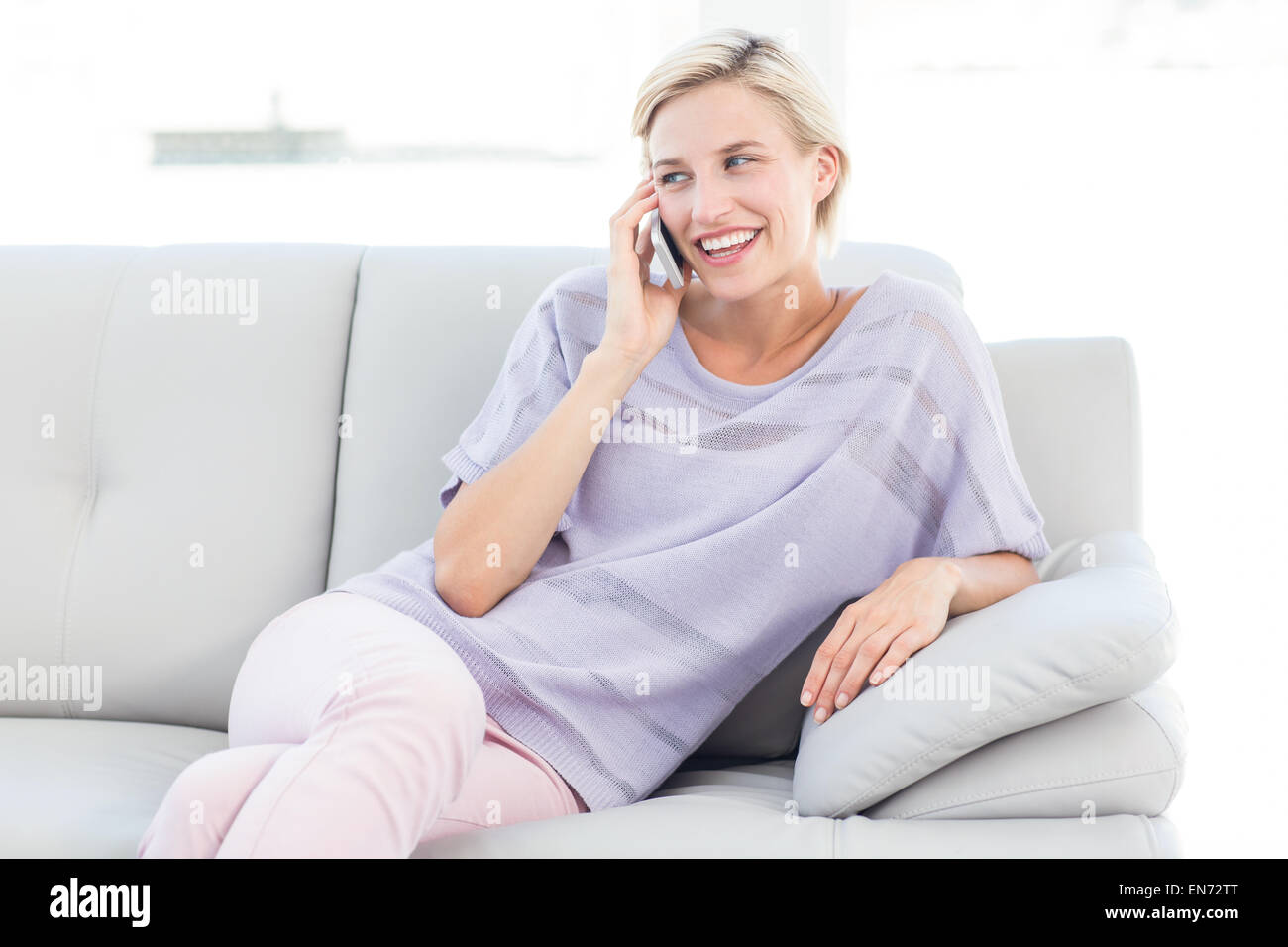 Pretty blonde woman calling on the phone Stock Photo - Alamy